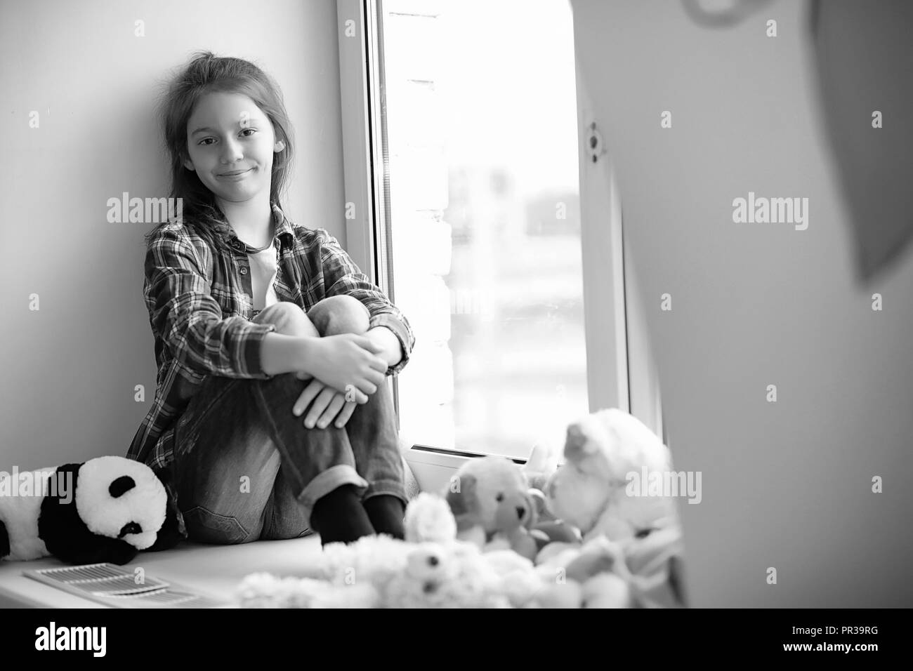 Child in the children's room. The kid is sitting on the windowsi Stock ...