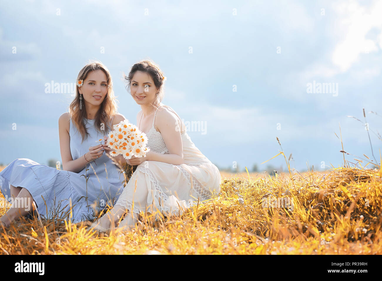 Two girls in dresses in autumn field Stock Photo - Alamy