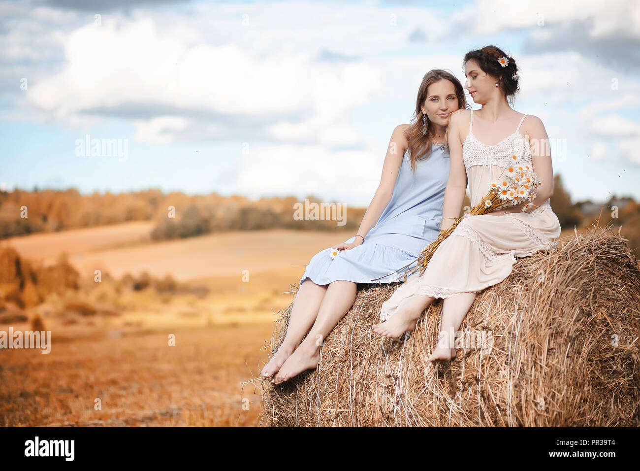 Two girls in dresses in autumn field Stock Photo - Alamy