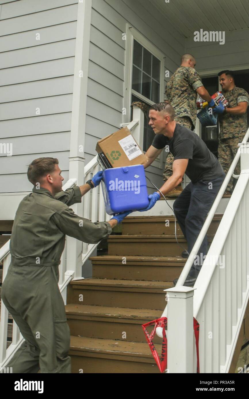 Military policemen volunteer to help a family by removing personal ...