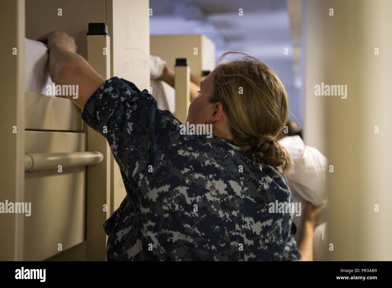 A U.S. Naval ROTC Midshipman makes her rack during Career Orientated ...