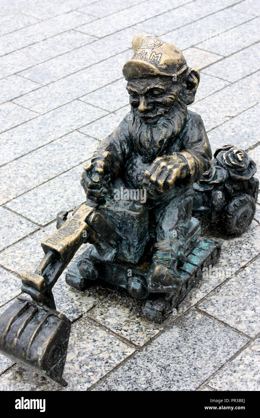 A dwarf driving a digger on the path by the river in Wroclaw, Poland ...