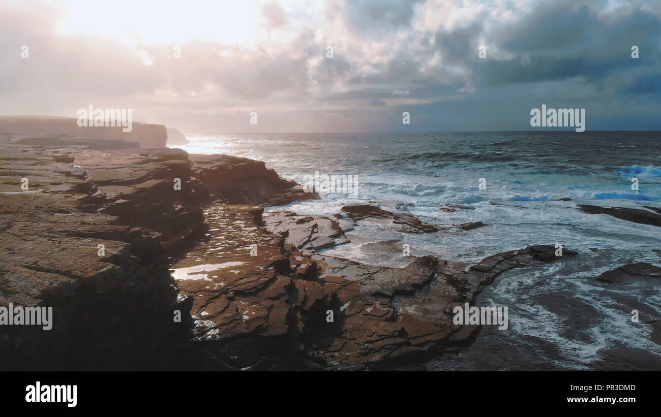 Low Aerial view over the rocky bay of Kilkee at the Irish west coast ...