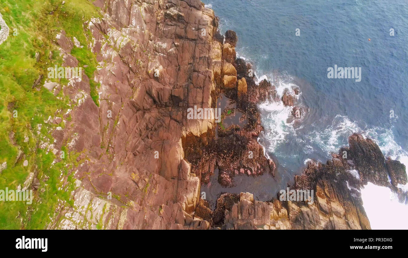 Blue Atlantic Ocean water hits the cliffs of Dingle Peninsula in ...