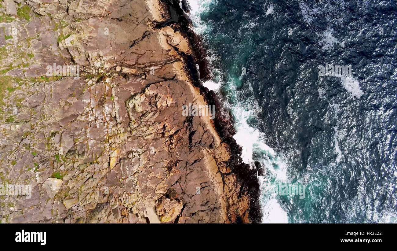 Deep blue ocean water and steep cliffs from above Stock Photo - Alamy
