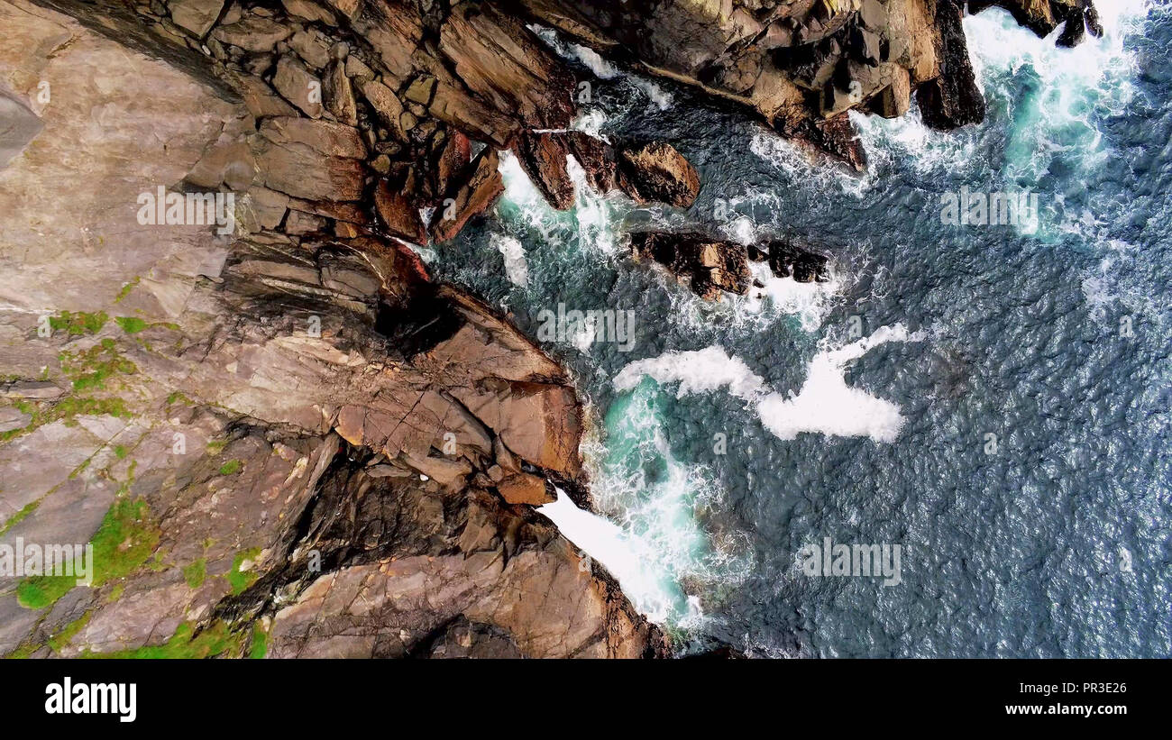 Deep blue ocean water and steep cliffs from above Stock Photo - Alamy