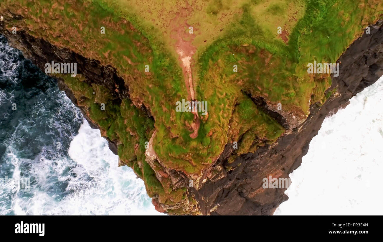 Couple stands on the edge of a cliff Stock Photo - Alamy