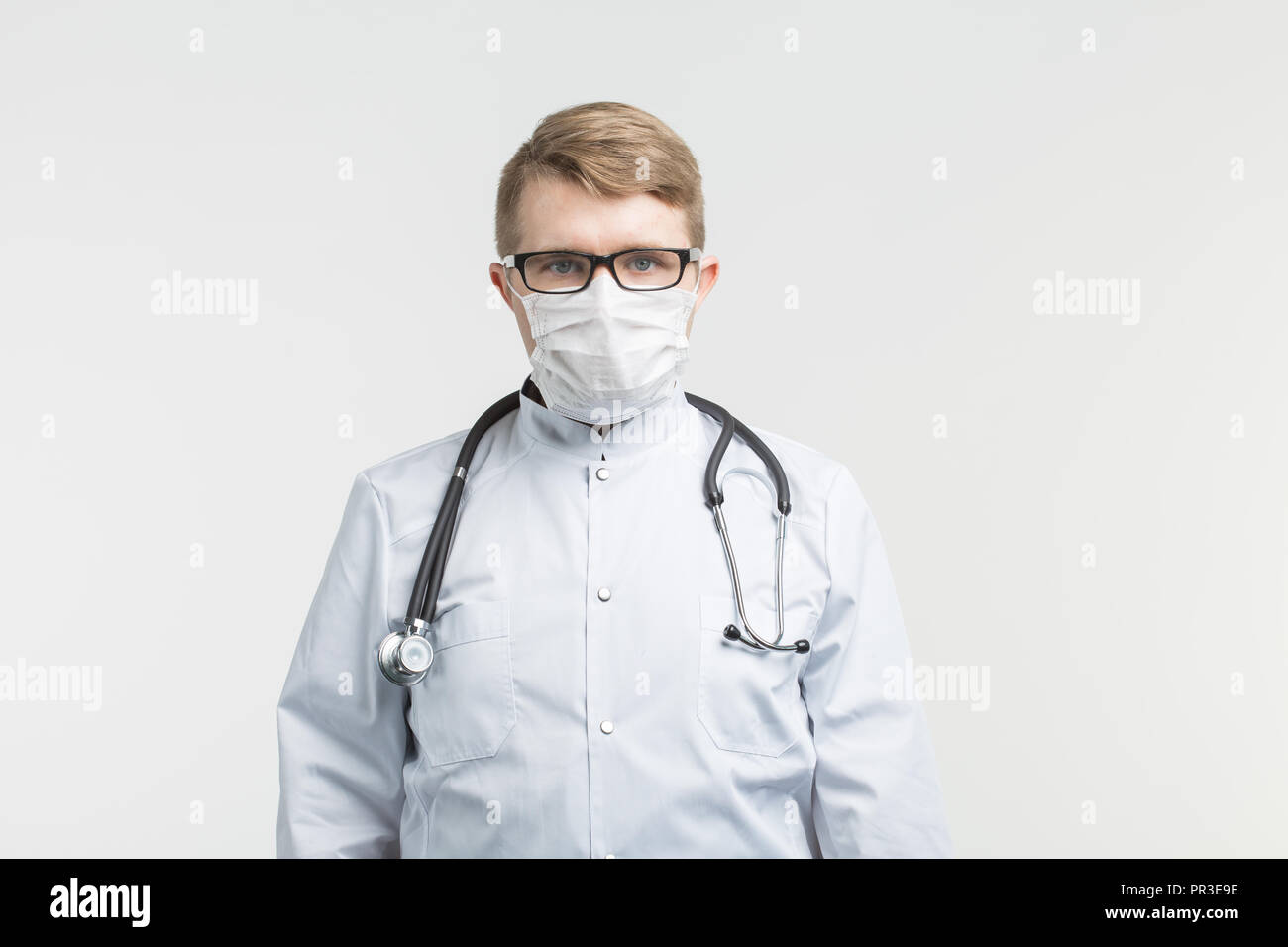 Health and medicine - doctor wearing the stethoscope and white mask on ...