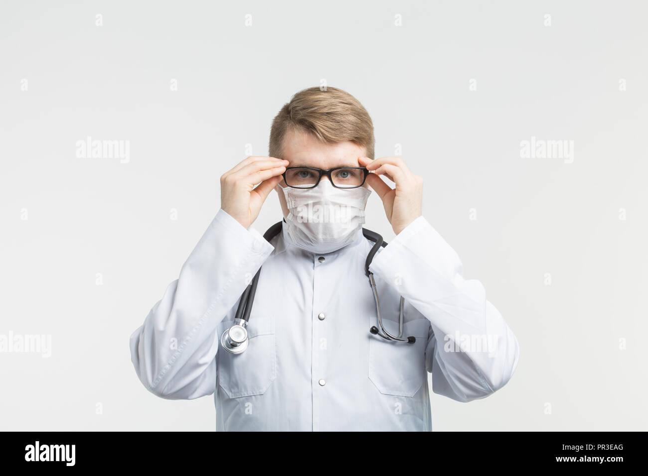 Health and medicine - doctor wearing the stethoscope and white mask on ...
