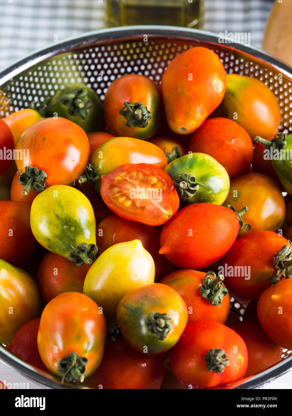 Italian tomatoes in a colander on table. Cooking with tomatoes concept ...