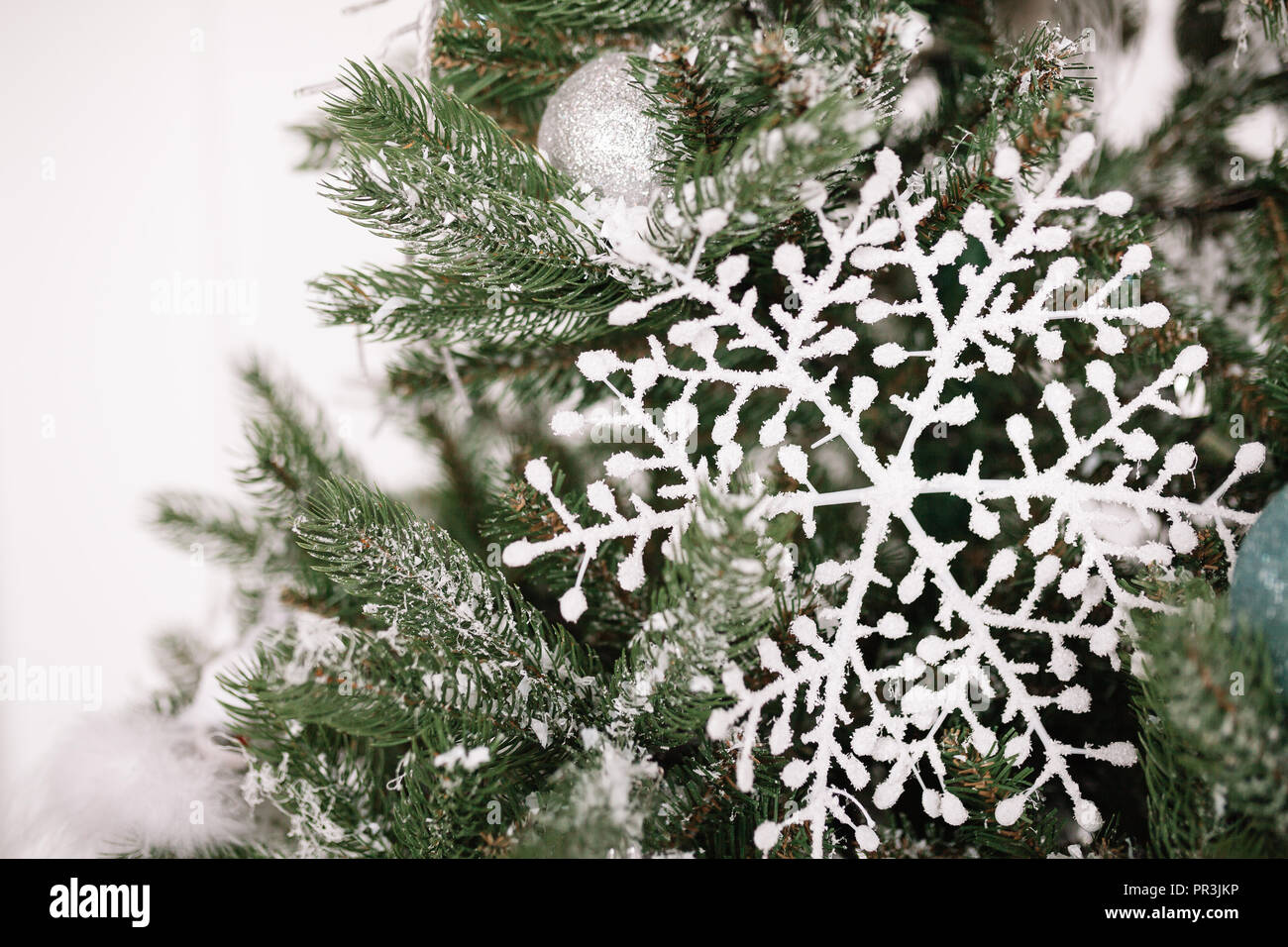 White snowflake at the powdered with snow christmas tree Stock Photo ...