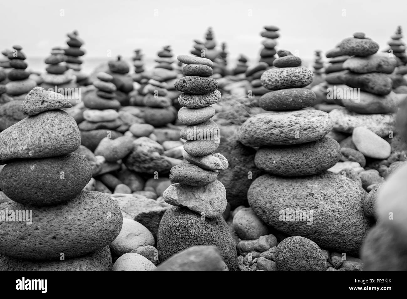 A pile of pebbles is built in the form of a pyramid. Black and white ...