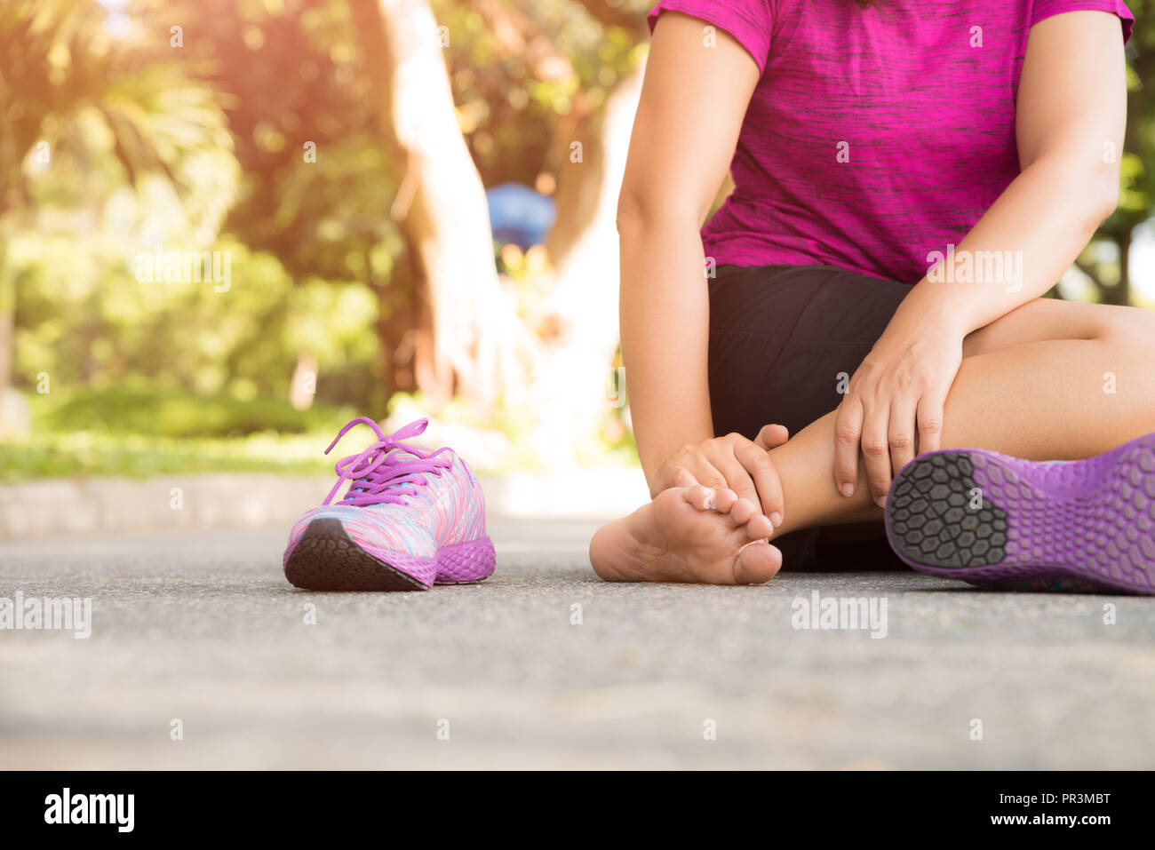 Woman suffering from an ankle injury while exercising. Running sport ...