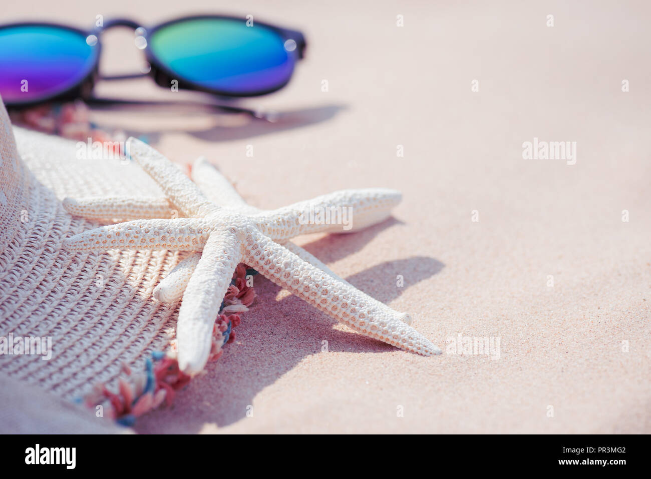 Soft focus on starfish. Beach accessories including sunglasses ...