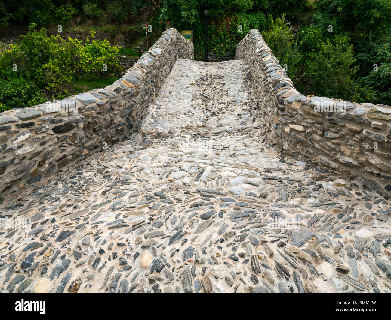 Old cobbled Roman bridge ot Puento Romano in Mudejar route mountain ...