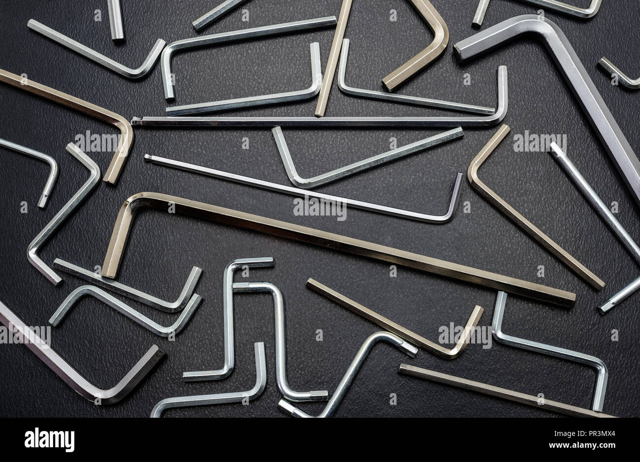 A lot of allen keys lying on a black, shiny table, front view Stock ...
