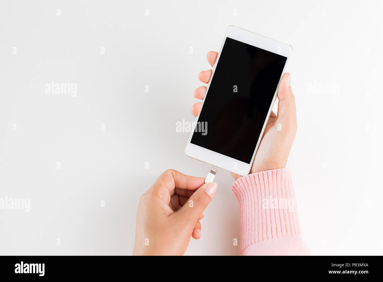 Woman connecting charging cable hi-res stock photography and images - Alamy