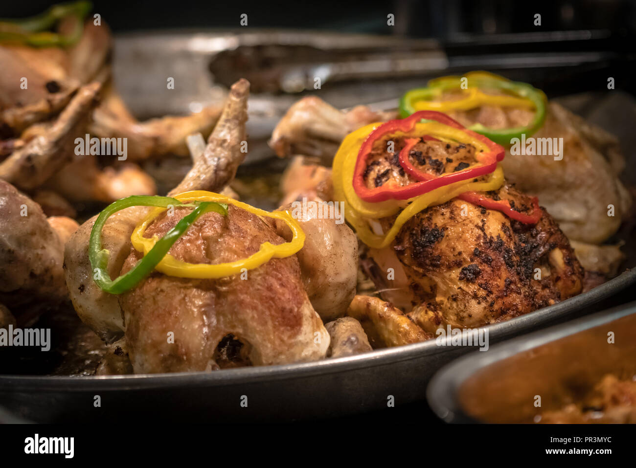 Roasted chickens and vegetables in tray on the self service hot counter ...