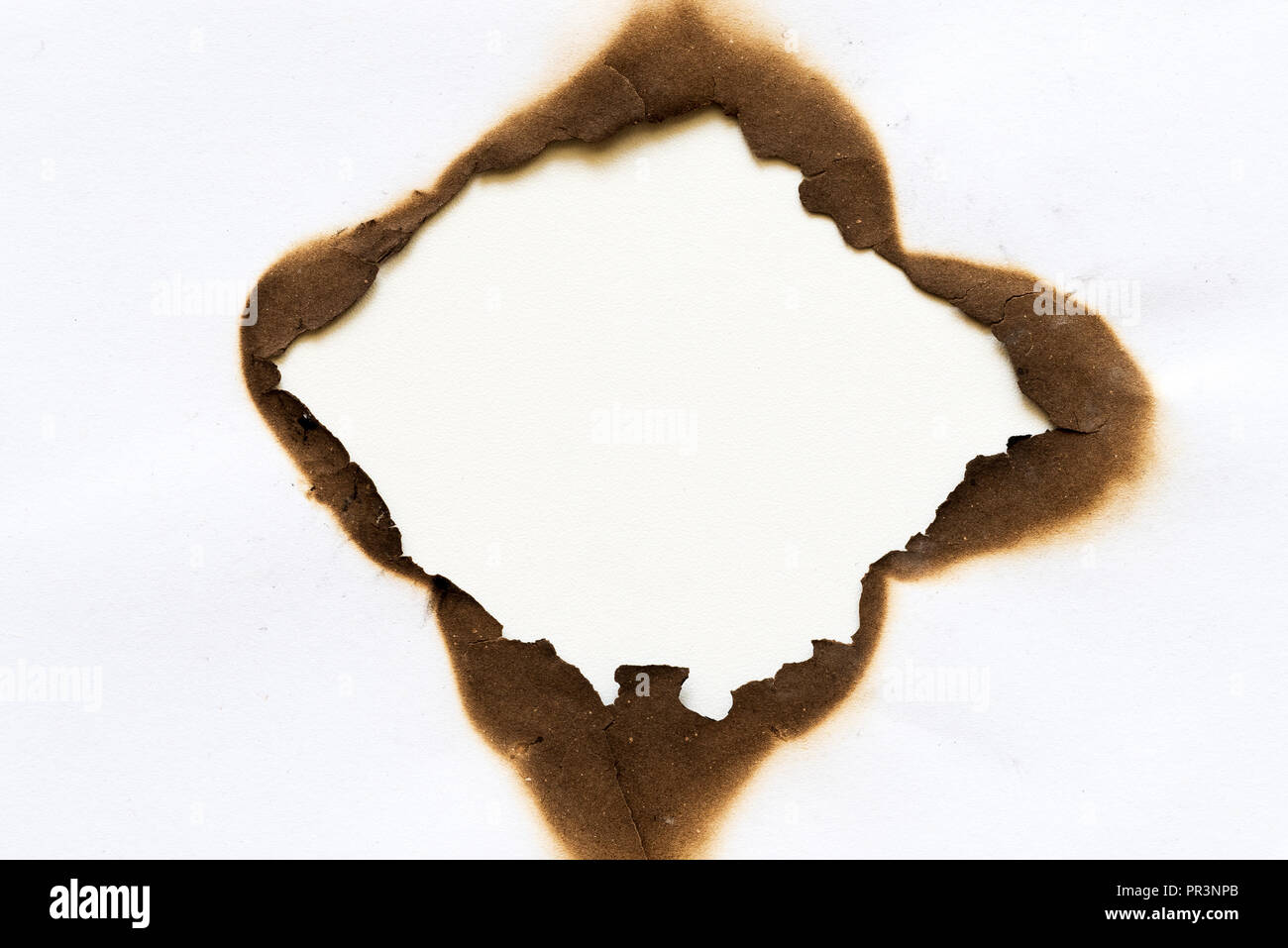 burned hole on piece of paper isolated on white background Stock Photo ...