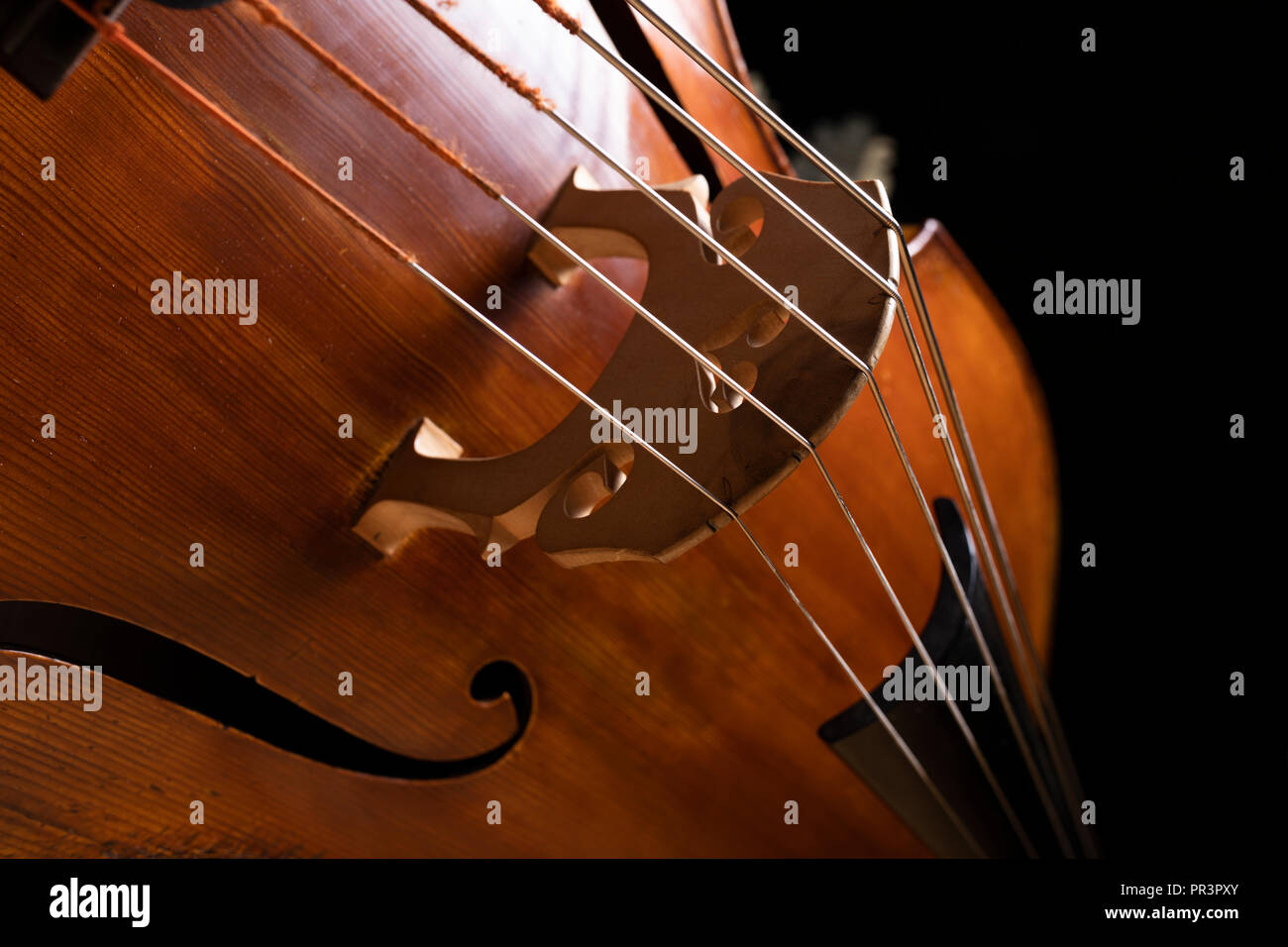 A part of a double bass on a dark background Stock Photo - Alamy
