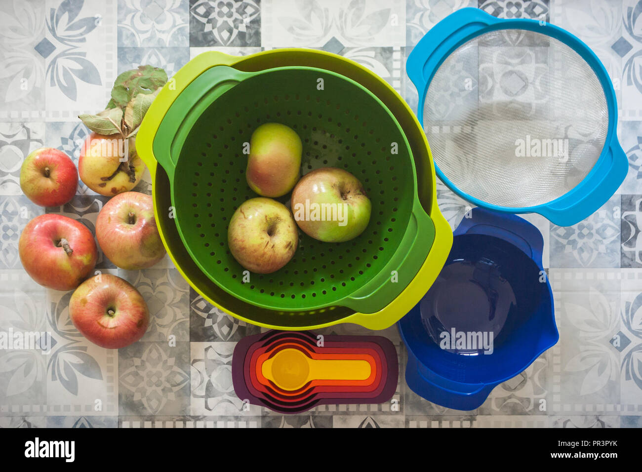 Freshly picked, organic apples on a table with colorful bowls and ...