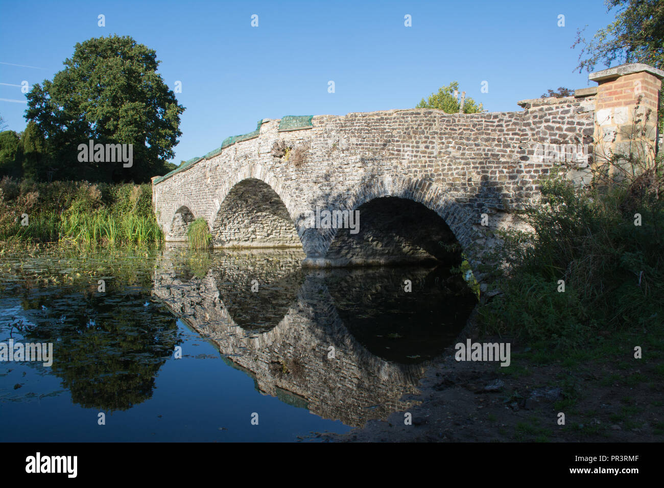 Picturesque arched stone bridge over the lake in front of Waverley ...