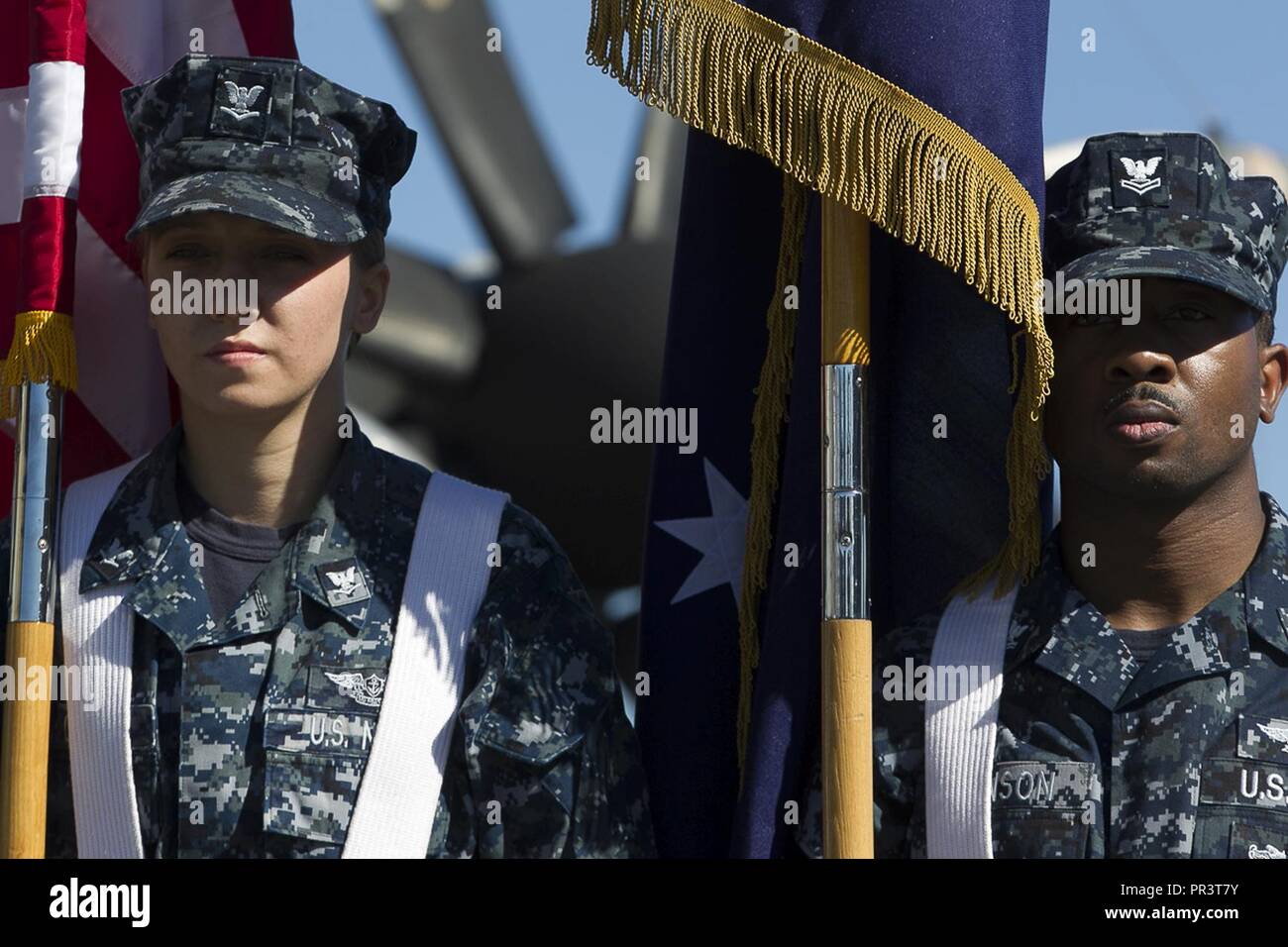 U.S. Navy Sailors, members of the ceremonial color guard, hold the U.S ...