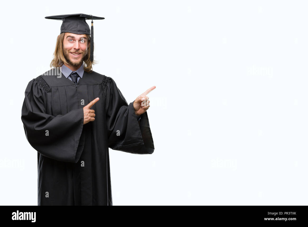 Young handsome graduated man with long hair over isolated background ...