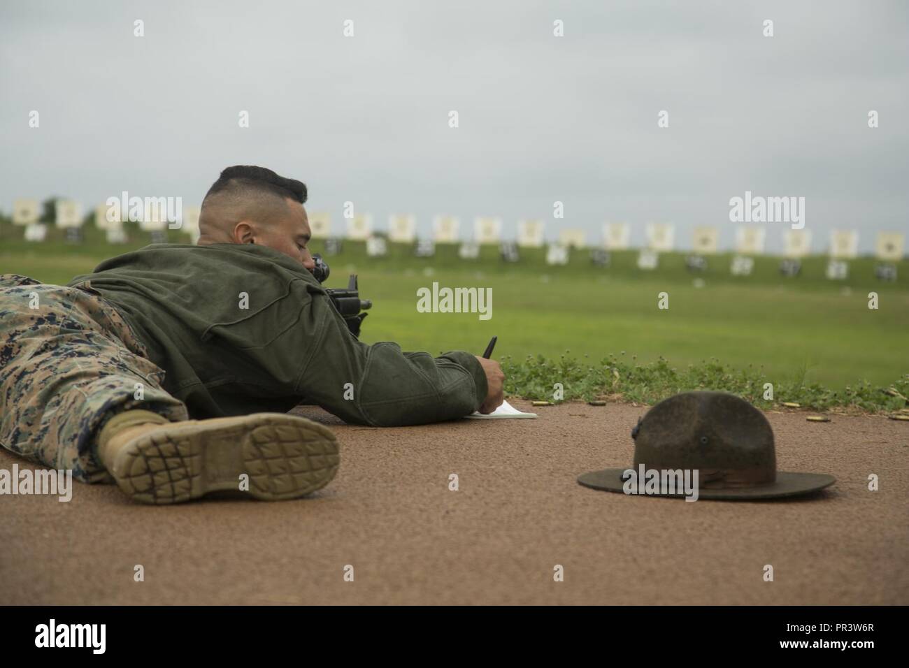 U.S. Marine Corps Sgt. Carlos Carmelo, primary marksmanship instructor ...