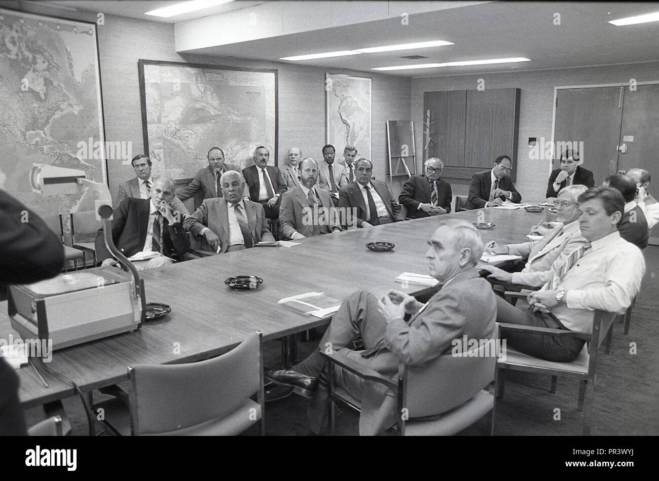 THERE ARE A GROUP OF MEN SITTING AROUND THE TABLE IN A MEETING Stock ...