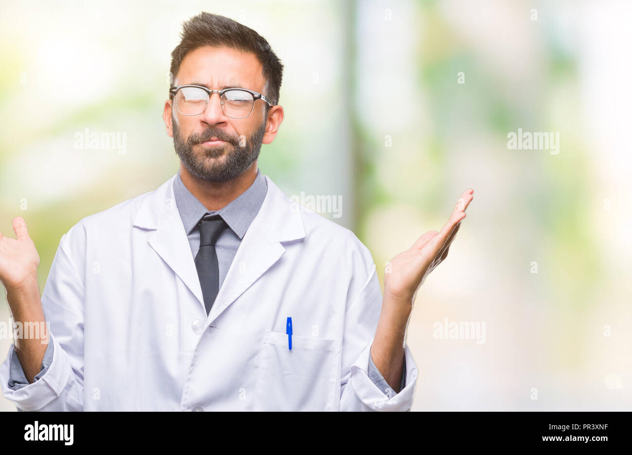 Adult hispanic scientist or doctor man wearing white coat over isolated ...