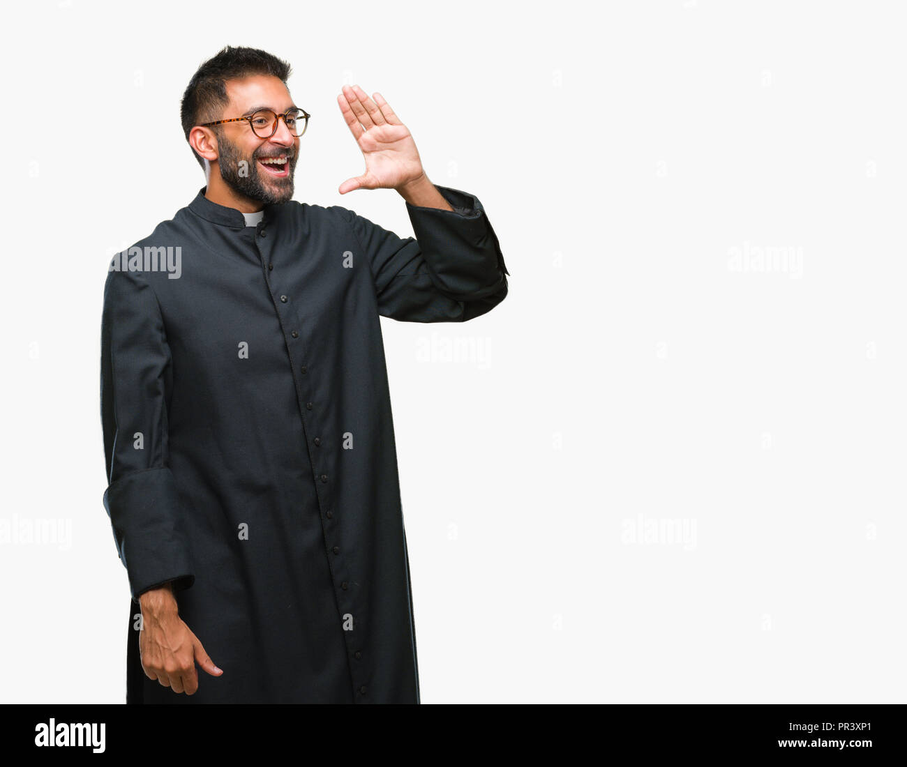 Adult hispanic catholic priest man over isolated background shouting ...