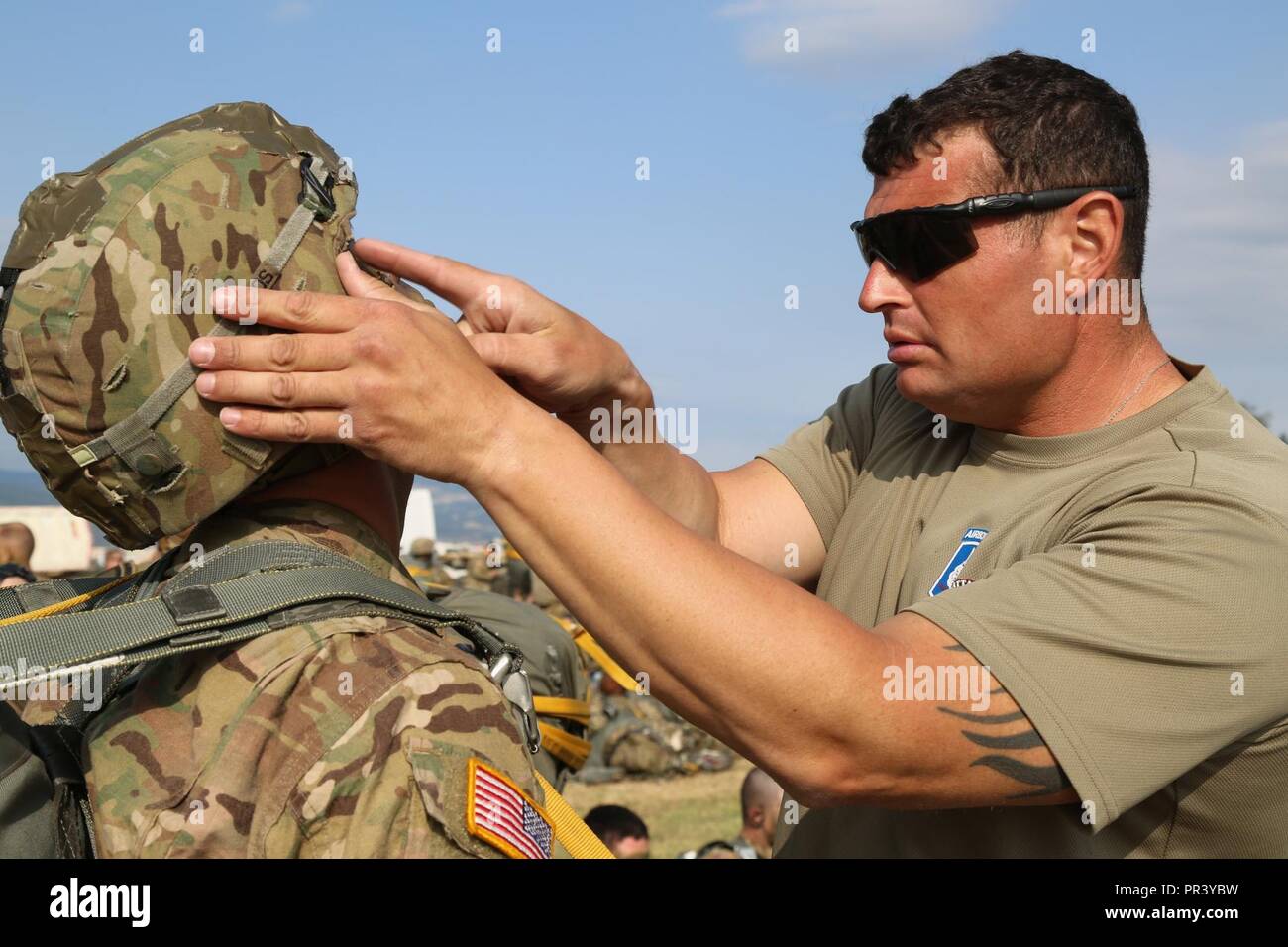 U.S. Army Staff Sgt. David Thomas, jumpmaster, checks a Soldier's gear ...