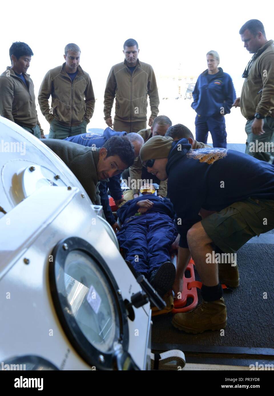 Petty Officer 1st Class Kim Nguyen (on stretcher) is lifted into a U.S ...