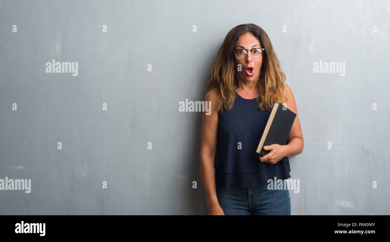 Woman shock reading book library hi-res stock photography and images ...
