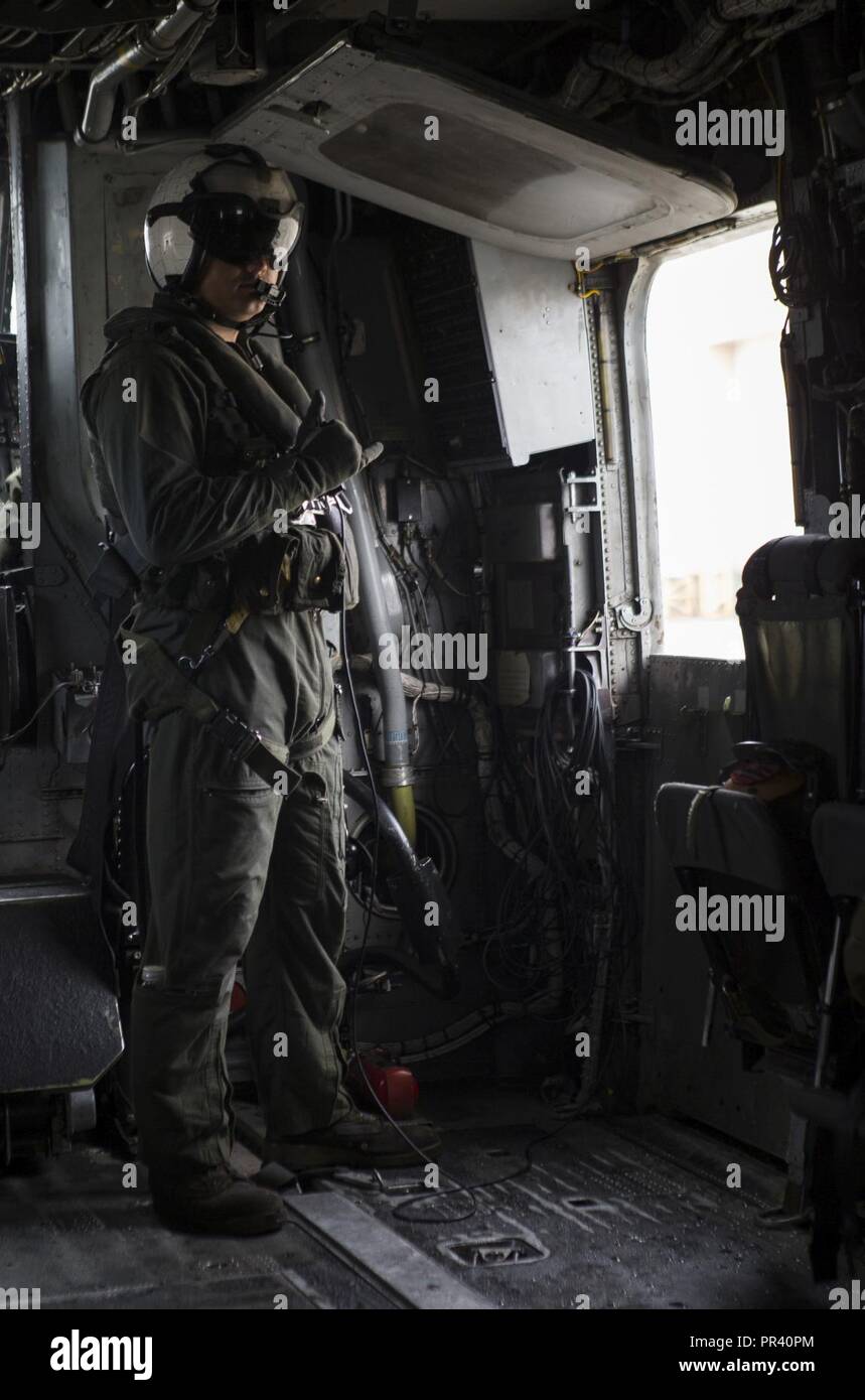 A crewman with Marine Heavy Helicopter Squadron 463, throws up a ...
