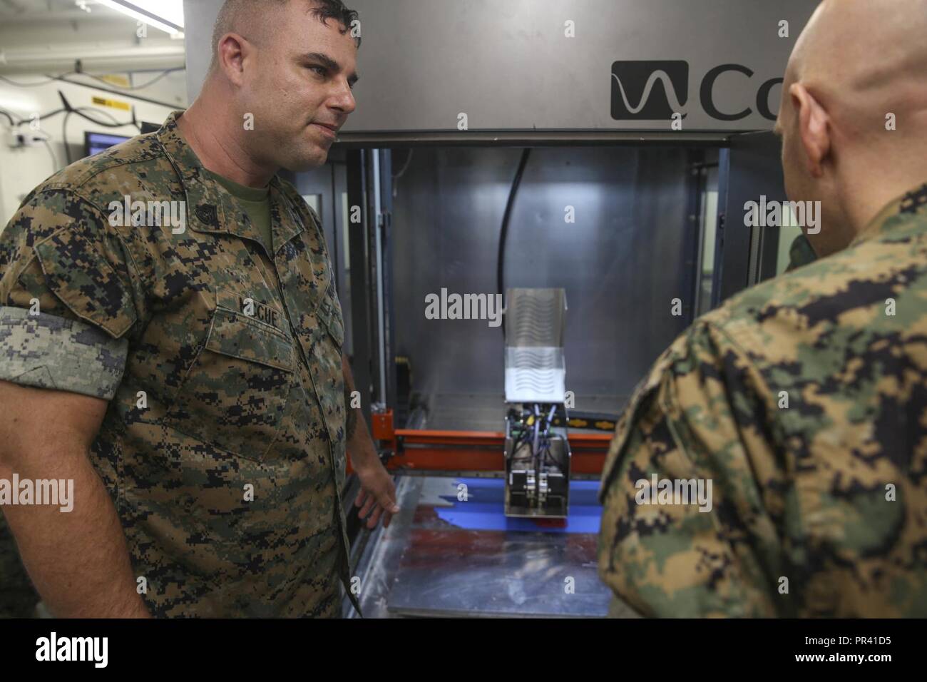 U.S. Marine Corps Gunnery Sgt. Douglas M. McCue, left, Machinest, 2nd ...