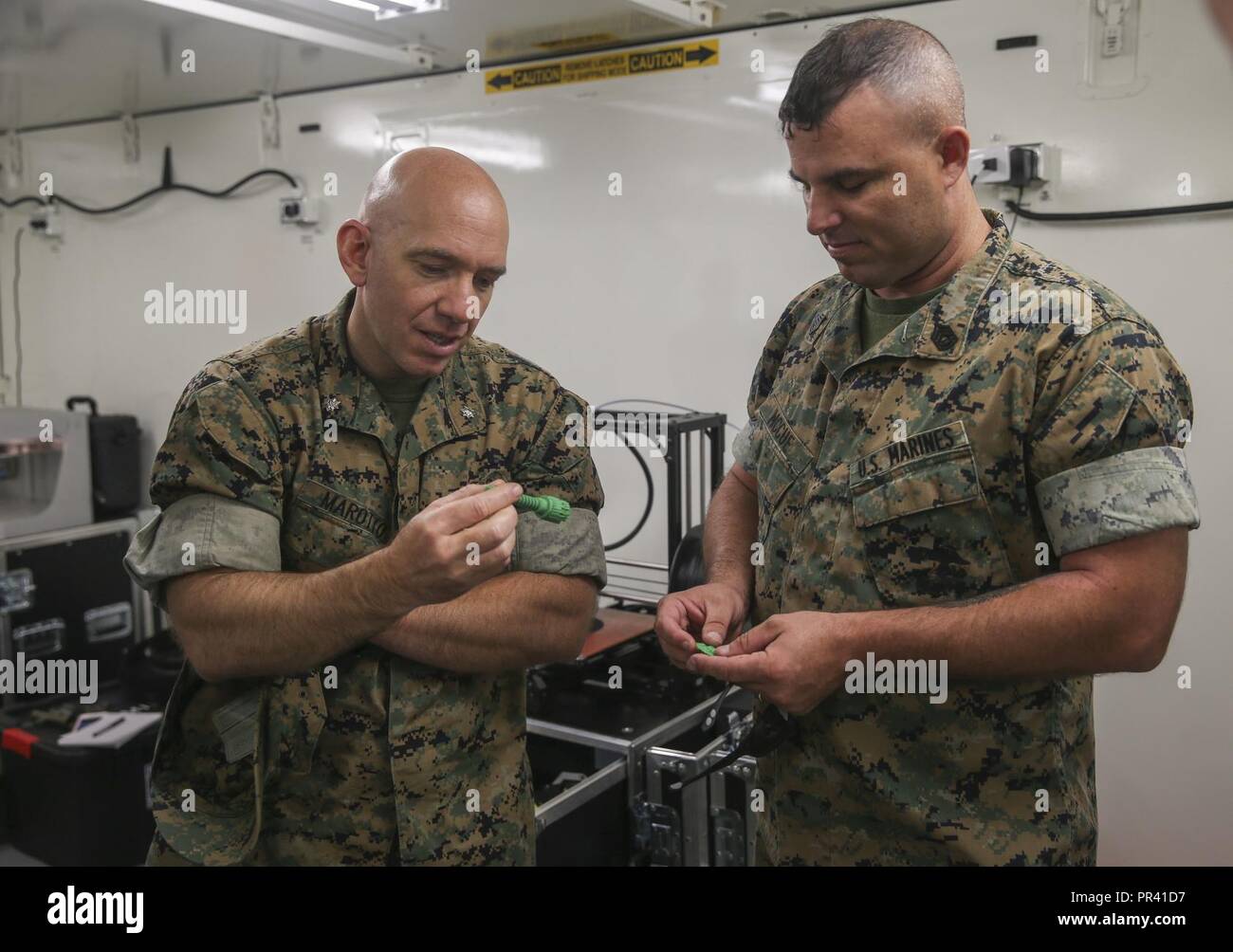 U.S. Marine Corps Lt. Col. Howard Marotto, left, is briefed by Gunnery ...