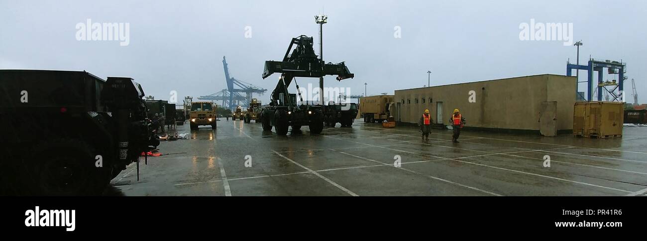 A Rough Terrain Container Handler, also referred to as a “RTCH,” pulls ...