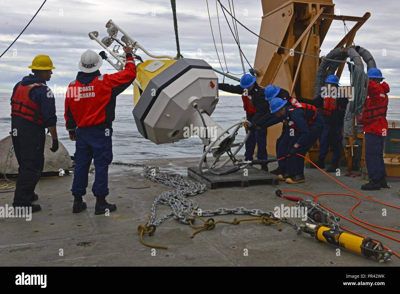 Coast Guard Cutter Healy crew members prepare to lower a NOAA buoy in ...