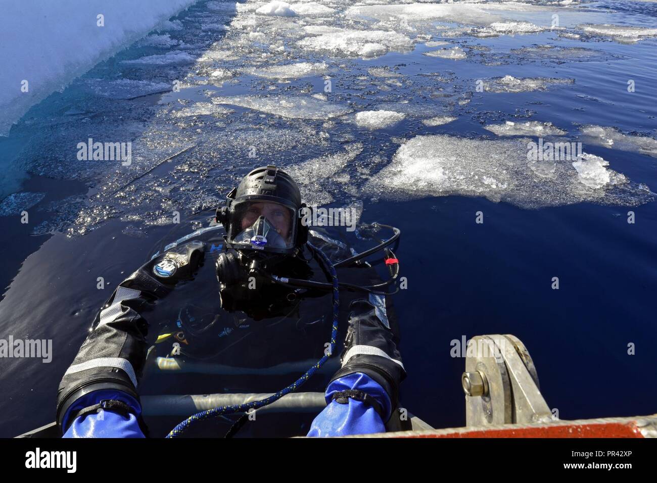 Coast Guard Chief Petty Officer Chuck Ashmore prepares to dive from a ...