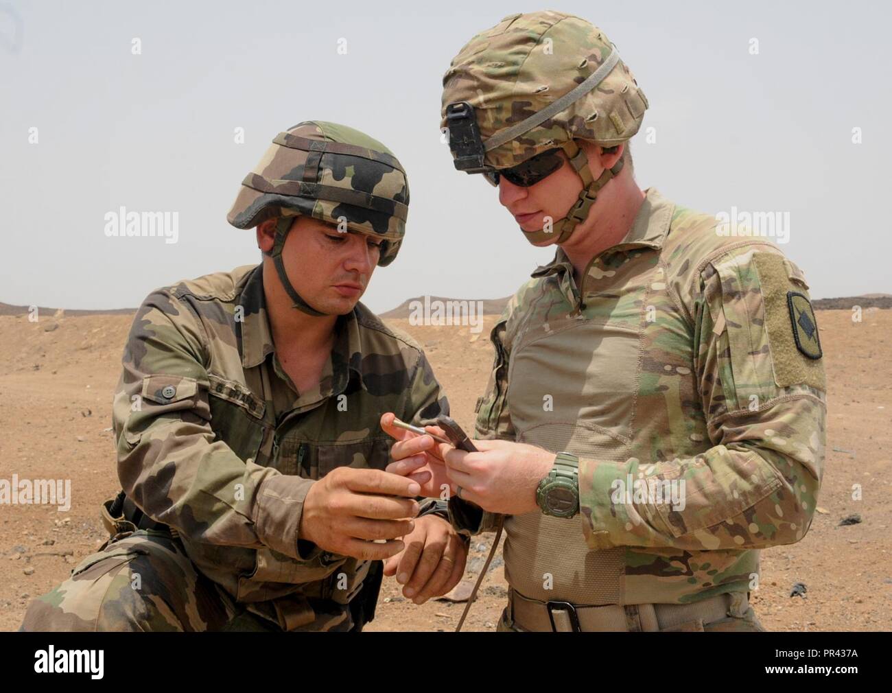 French service member explains how to prepare a primer for explosives ...