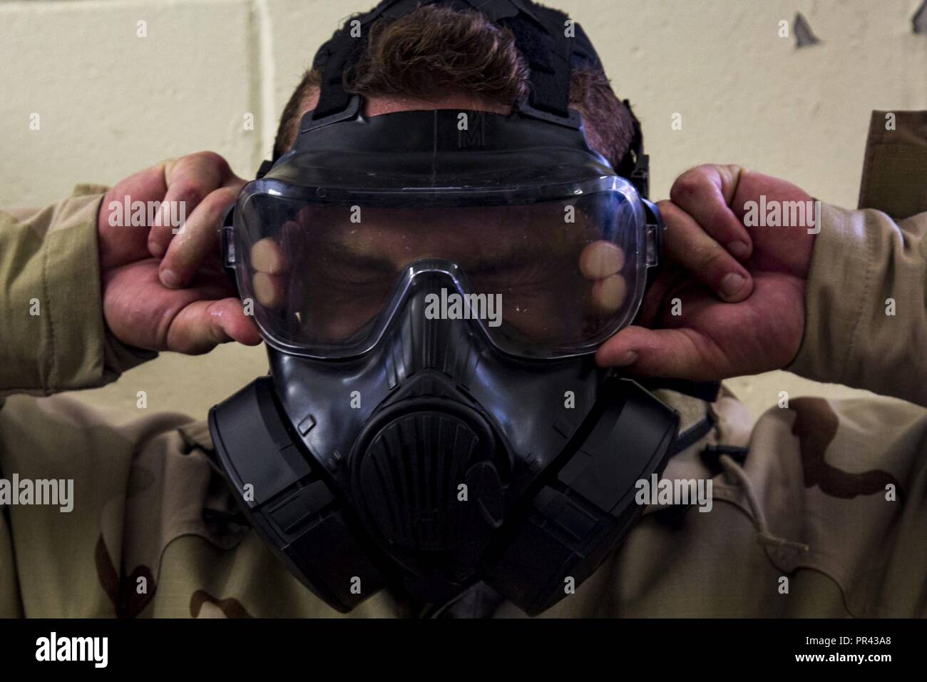 A U.S. Naval ROTC Midshipman breaks the seal to his M50 joint service ...