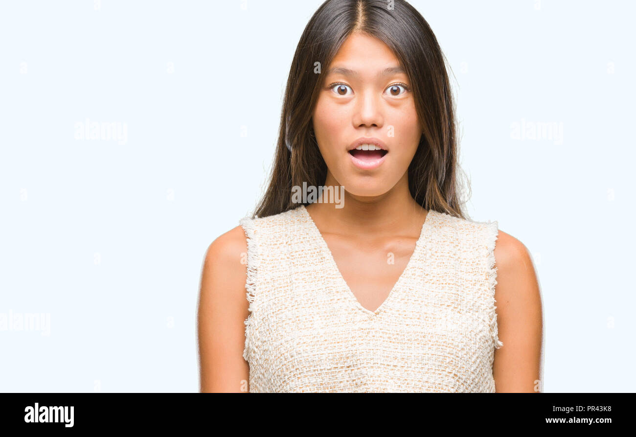 Young asian woman over isolated background afraid and shocked with ...