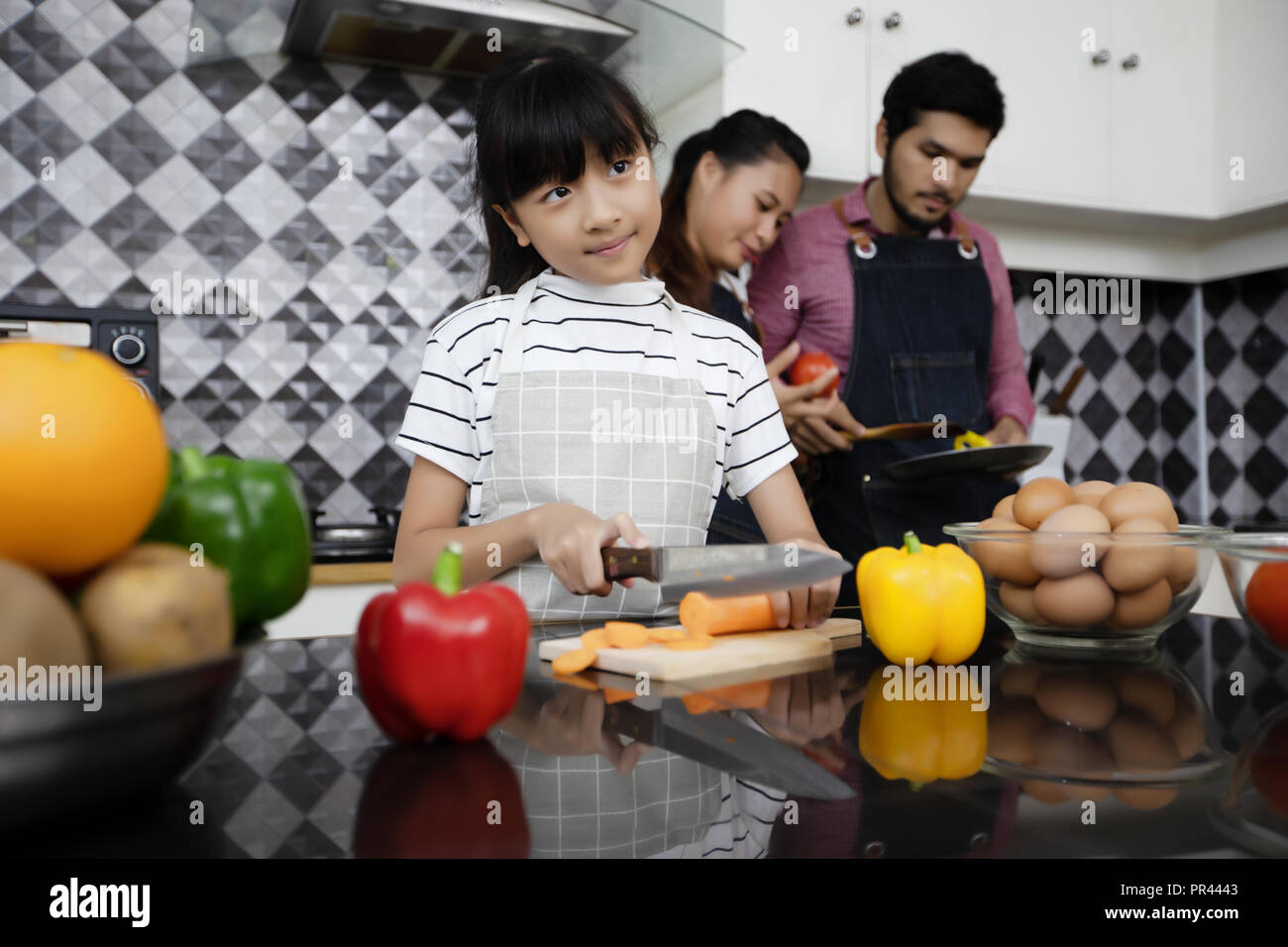 Happy Family have Dad, Mom and their little daughter Cooking Together ...