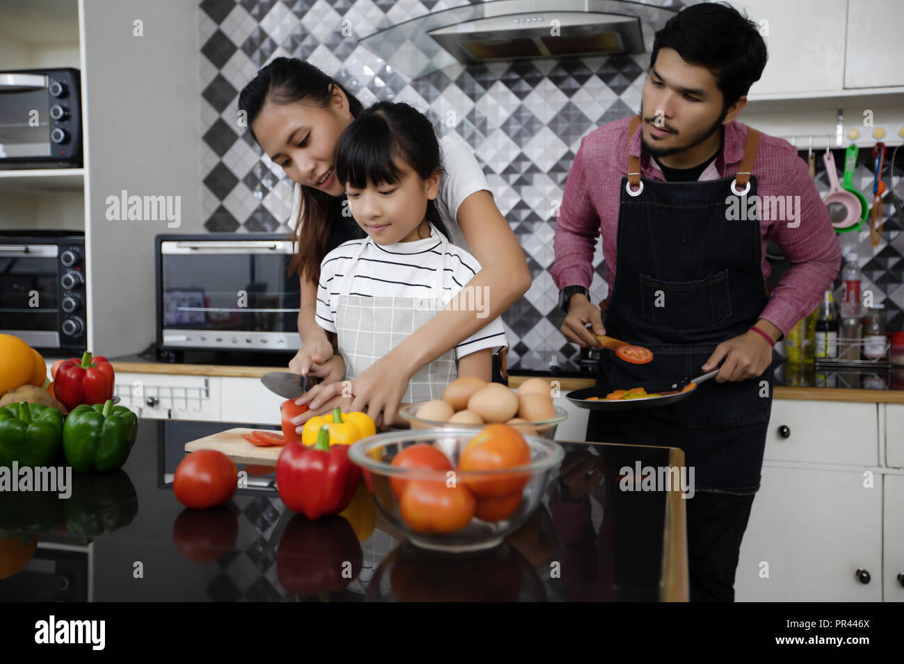 Happy Family have Dad, Mom and their little daughter Cooking Together ...