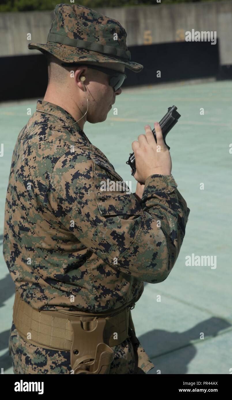 U.S. Marine Lance Cpl. Jacob Post checks his weapon during an annual ...