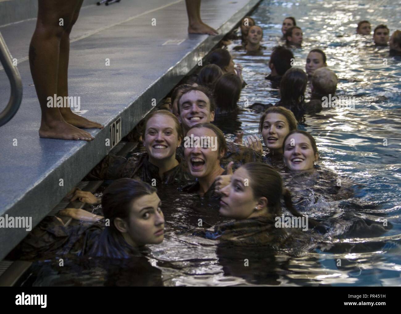 Members of the Queens University Swim Team pose for a photo during the ...