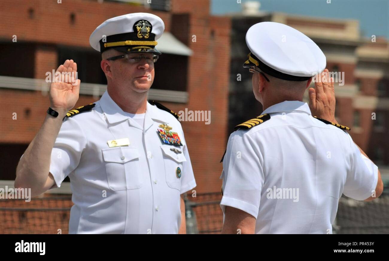 Lieutenant Commander Brian Ellis, USN, was promoted to the rank of ...