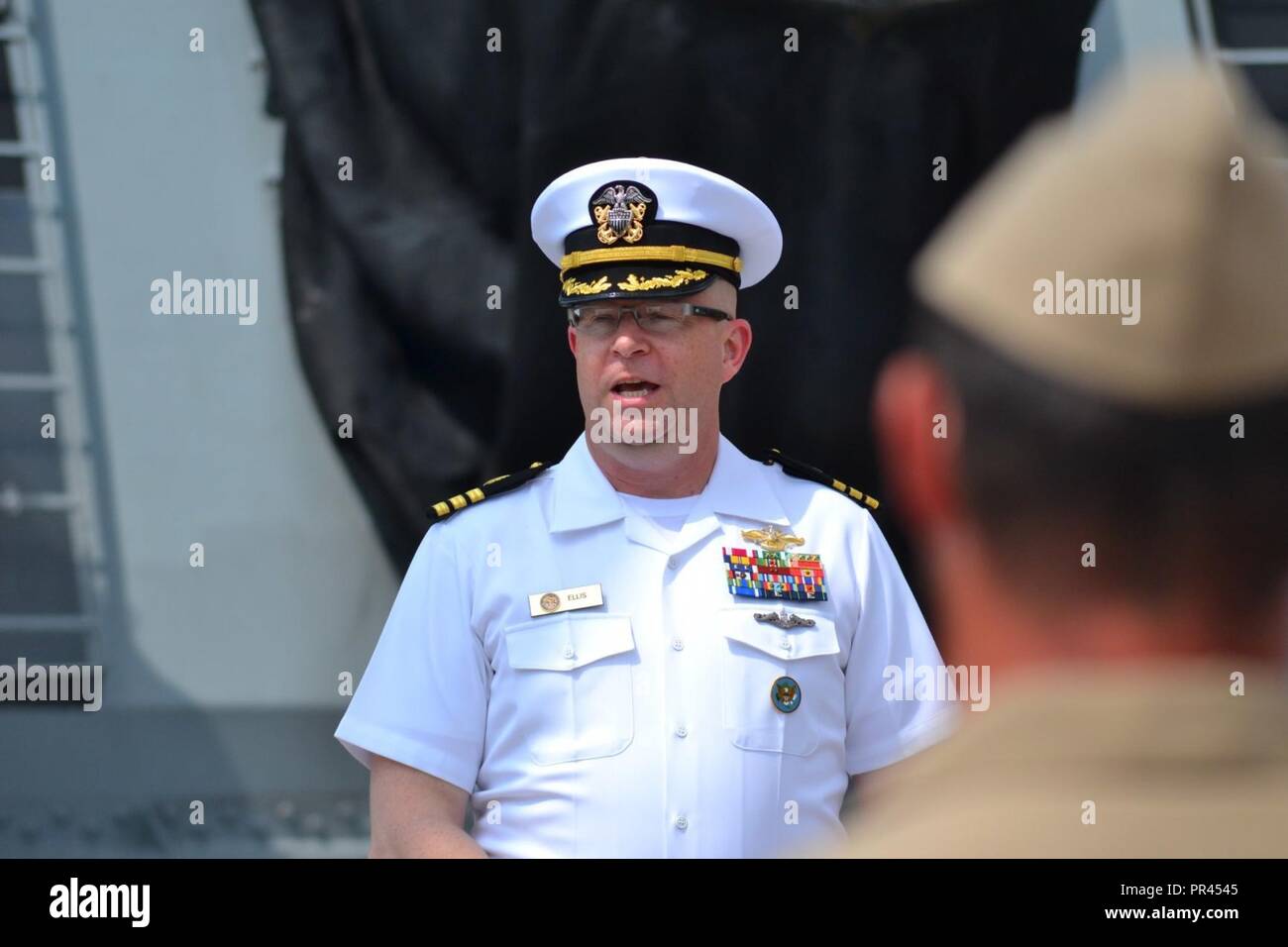 Lieutenant Commander Brian Ellis, USN, was promoted to the rank of ...
